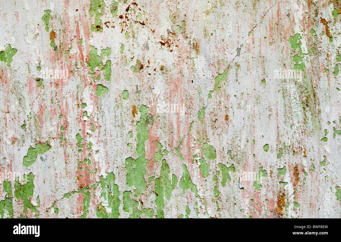 Background - a wall of the destroyed building with the damaged paint ...