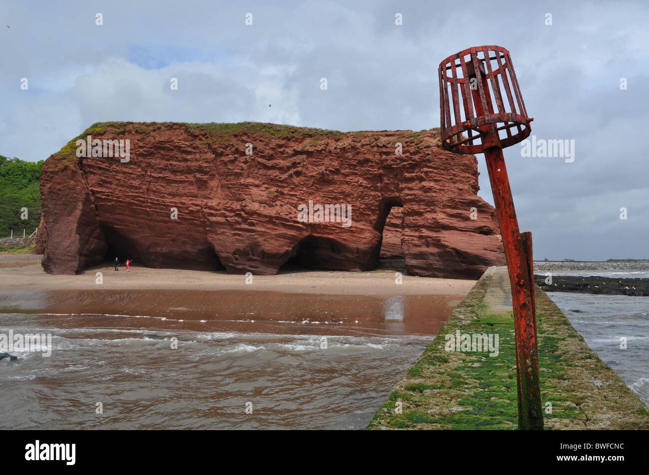 Red rock cliff, Dawlish Warren, Devon, viewed from the end of a jetty ...