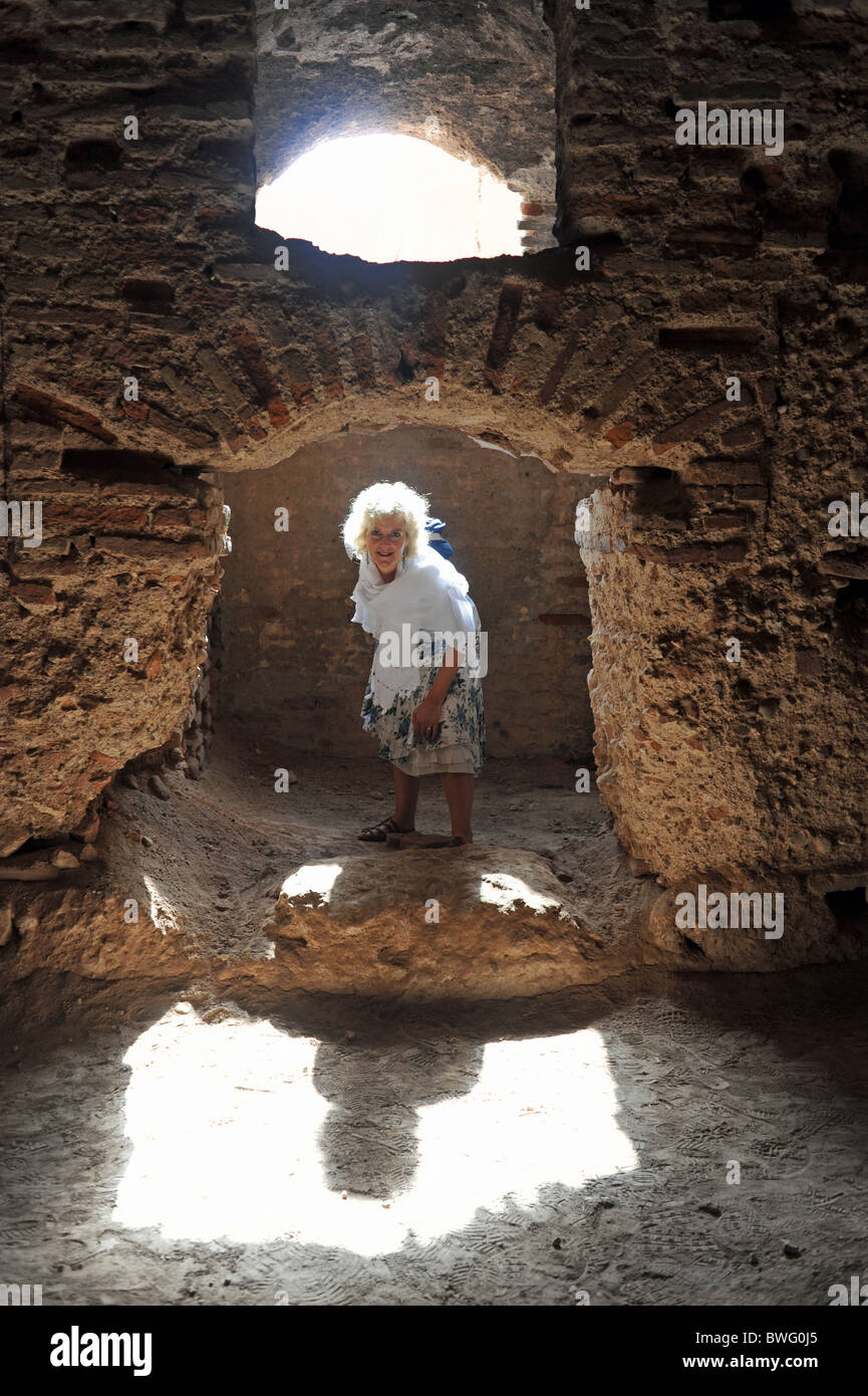 female tourist at the Underground prison cells at The Palais El Badii ...
