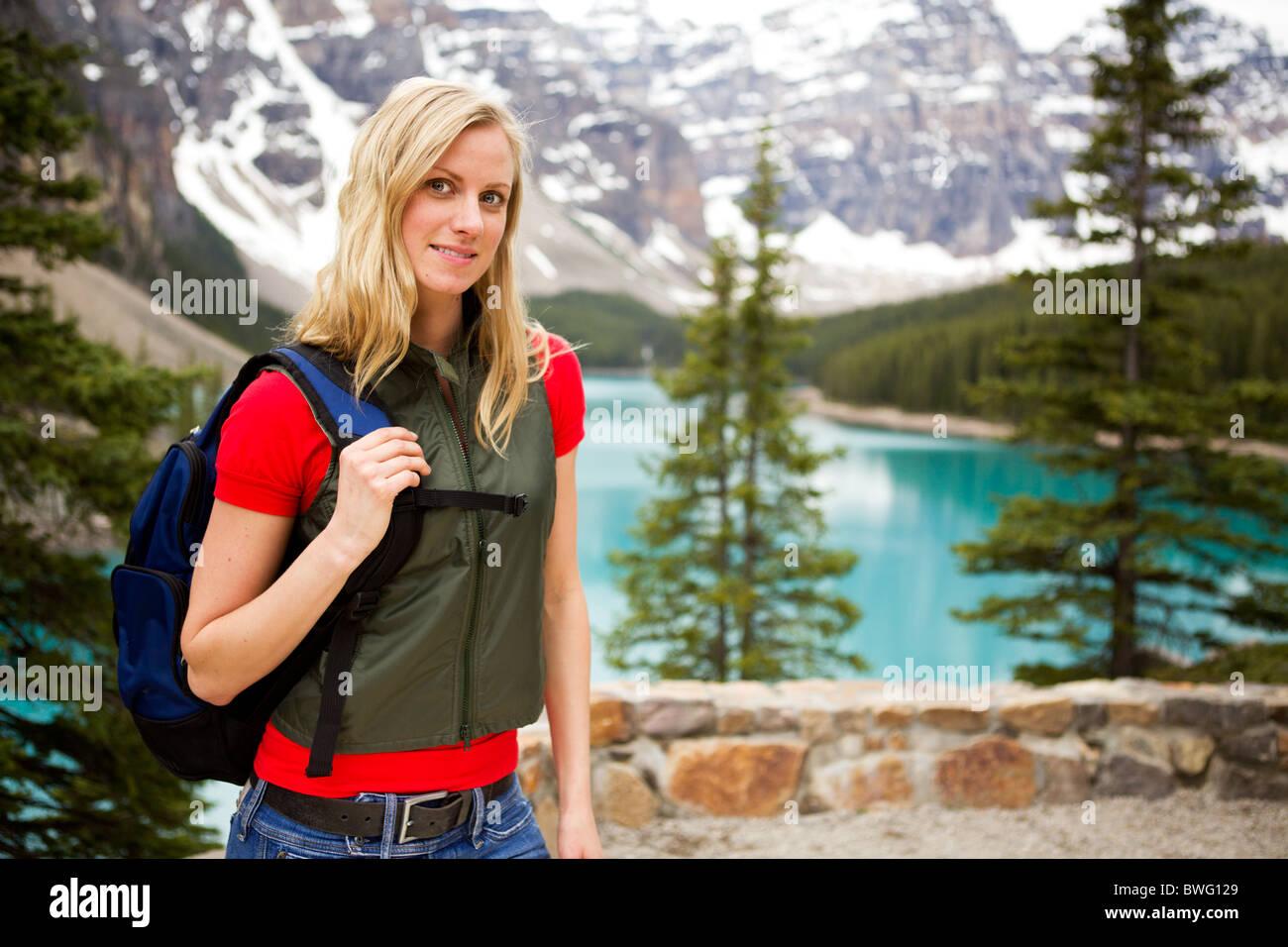 A portrait of a woman hiking on a mountain path near a lake Stock Photo ...