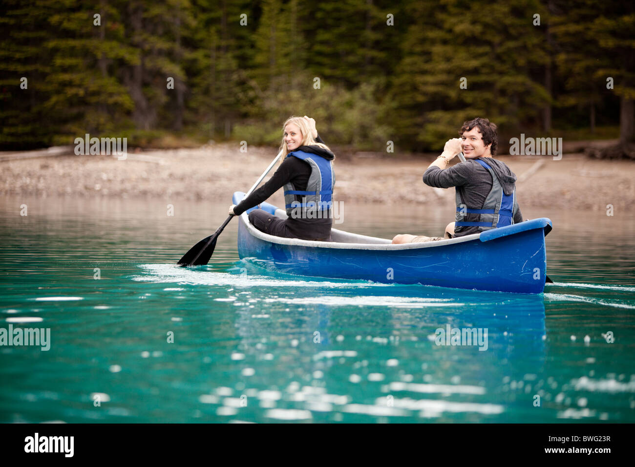 Man woman male female paddle paddling hi-res stock photography and ...