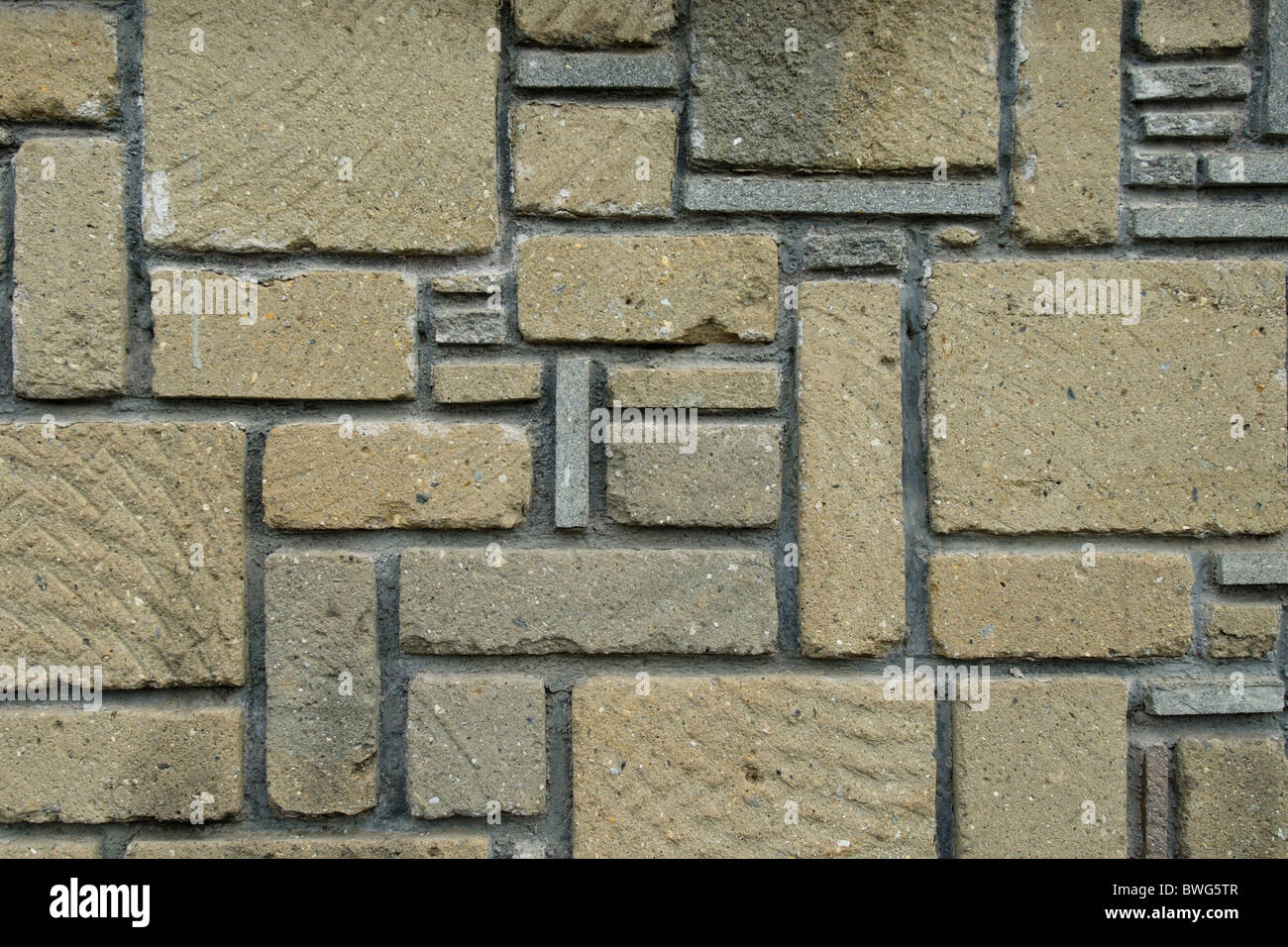 close up detail of brick wall made up of irregular rectangular blocks ...