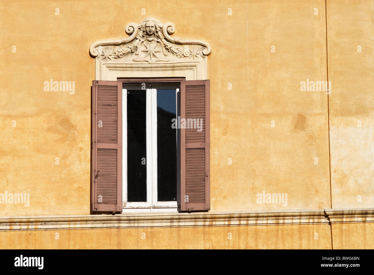 old shuttered window with decorative relief rome italy creates a ...