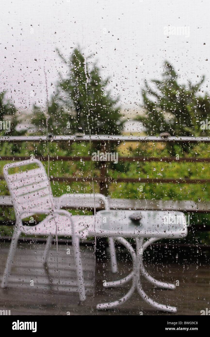 A rainy garden view from behind a screen Stock Photo - Alamy