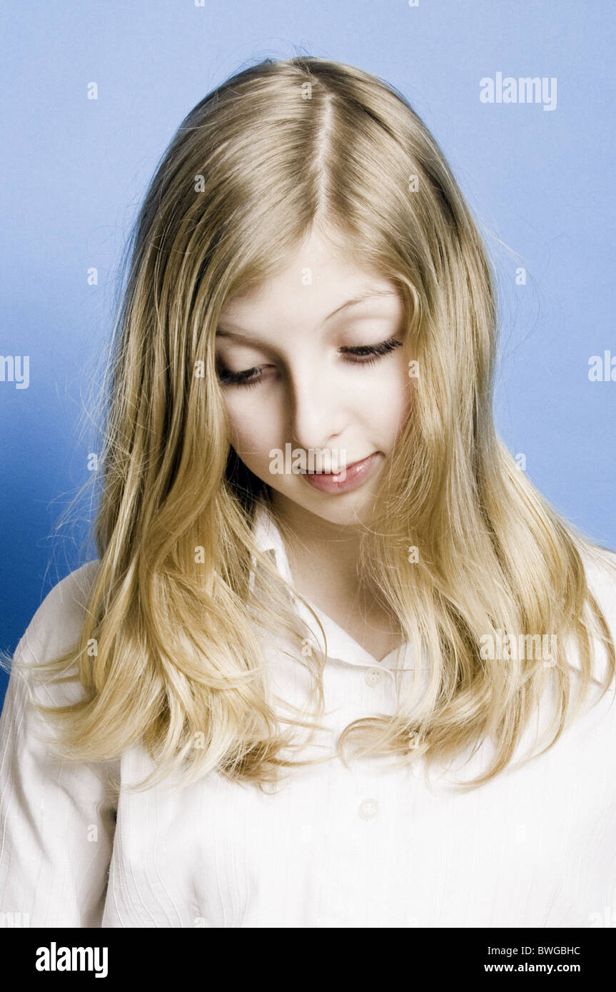 blonde girl with an amused expression Stock Photo - Alamy