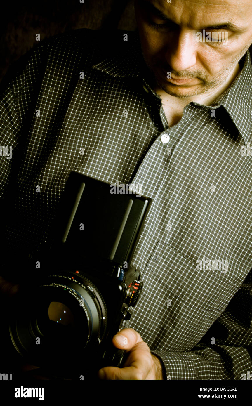 photographer with a medium format camera taking a photo Stock Photo - Alamy