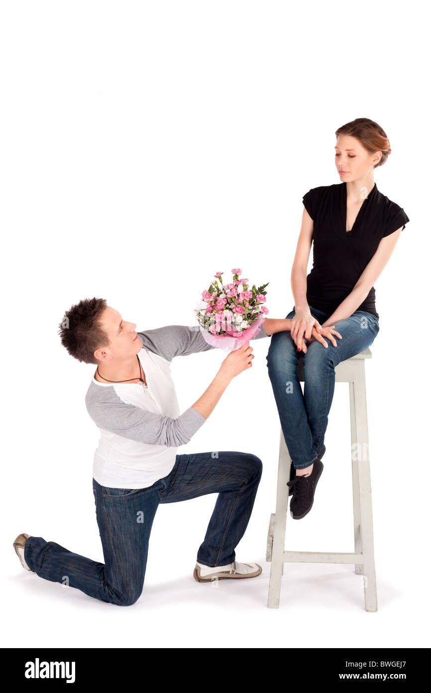 Man handing over bouquet of flowers to a beautiful young woman on ...