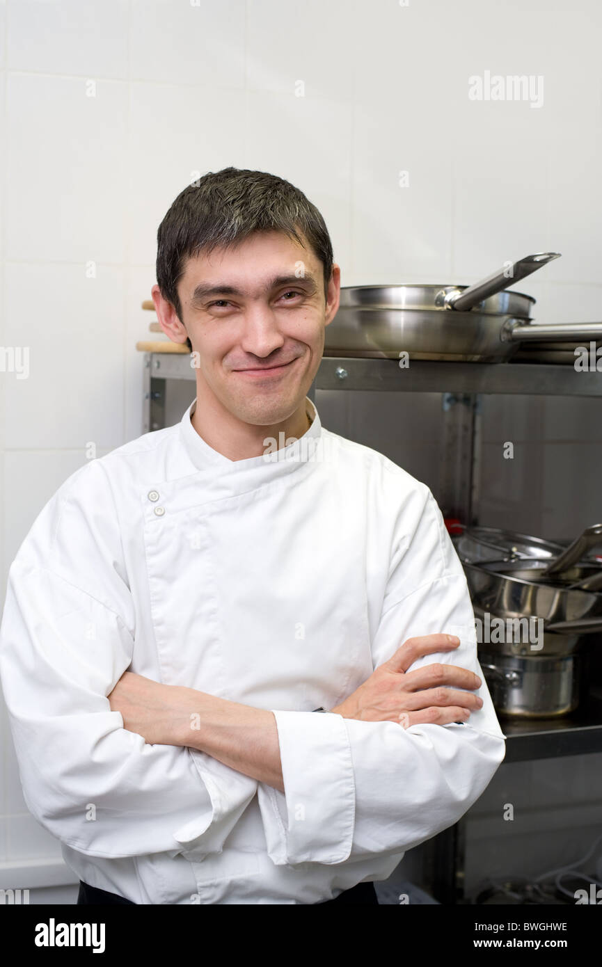 european chef with crossed arms looks smiling into camera Stock Photo ...