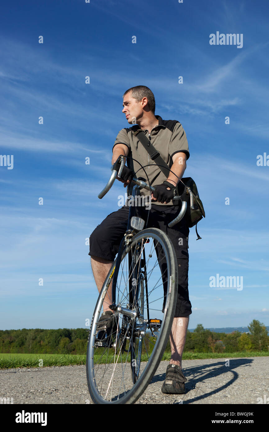Man standing with road bike Stock Photo - Alamy