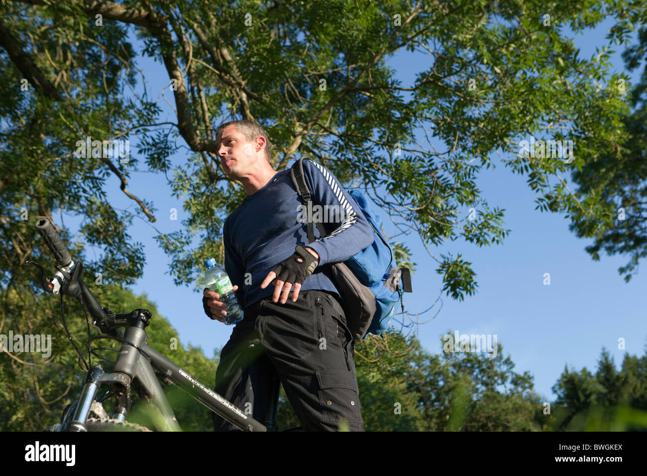 Man taking a break during cycling Stock Photo - Alamy