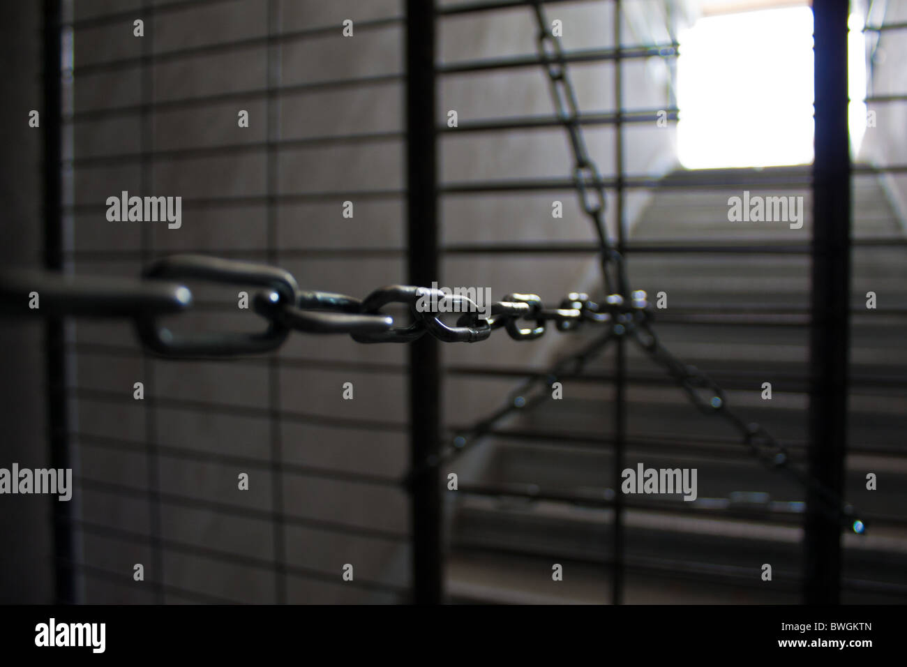 A chain keeping a fence up Stock Photo - Alamy