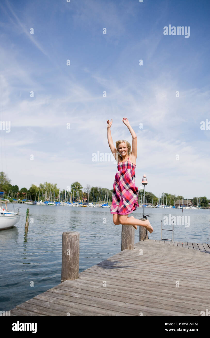 Girl jumping on bar Stock Photo - Alamy