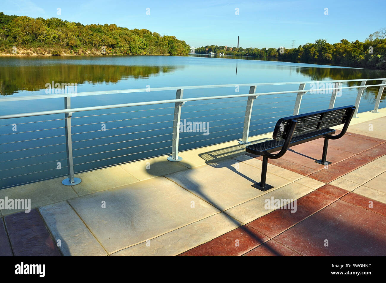 Bench at park overlooking river Stock Photo - Alamy