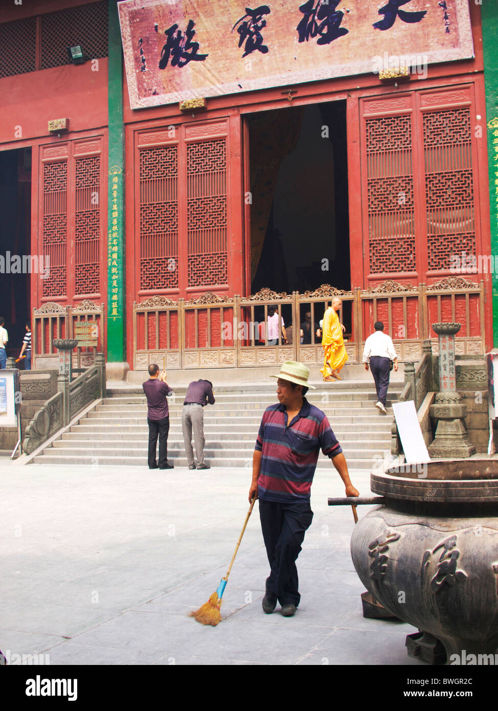 High in the mountains in Hangzhou, at a temple, while a Chinese cleaner ...