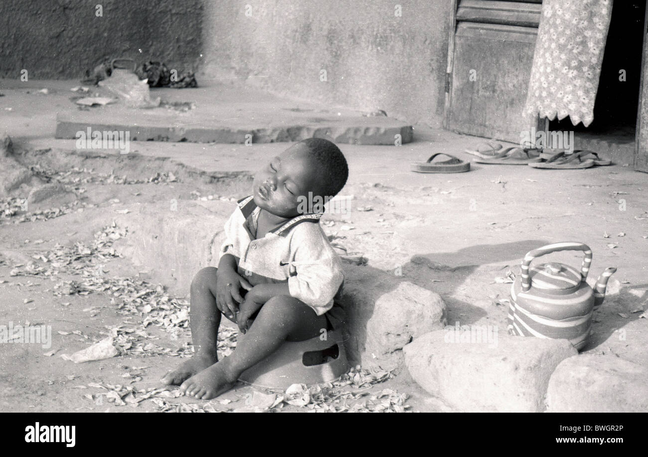 little African kid sleeping in his potty Stock Photo - Alamy