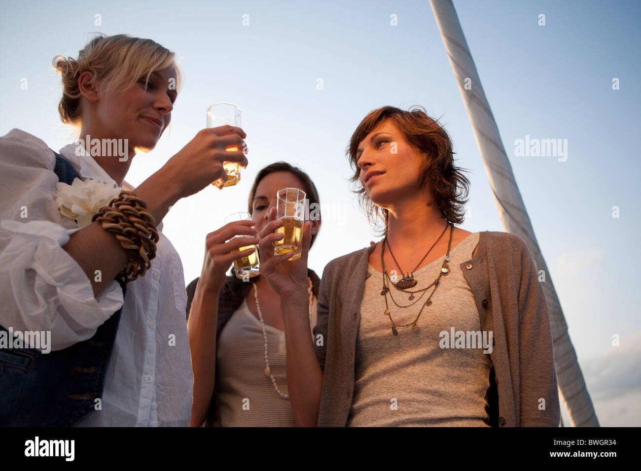 Girls drinking beer on boat Stock Photo - Alamy