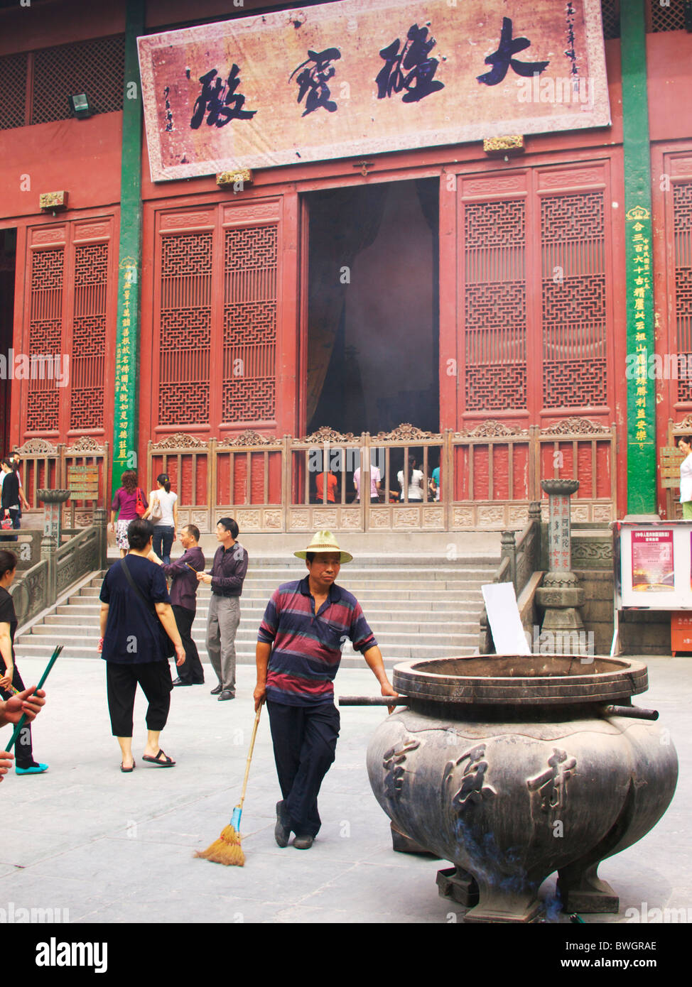 High in the mountains in Hangzhou, at a temple, while a Chinese cleaner ...