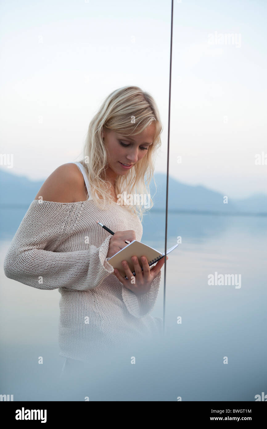 Girl writing in a book Stock Photo - Alamy