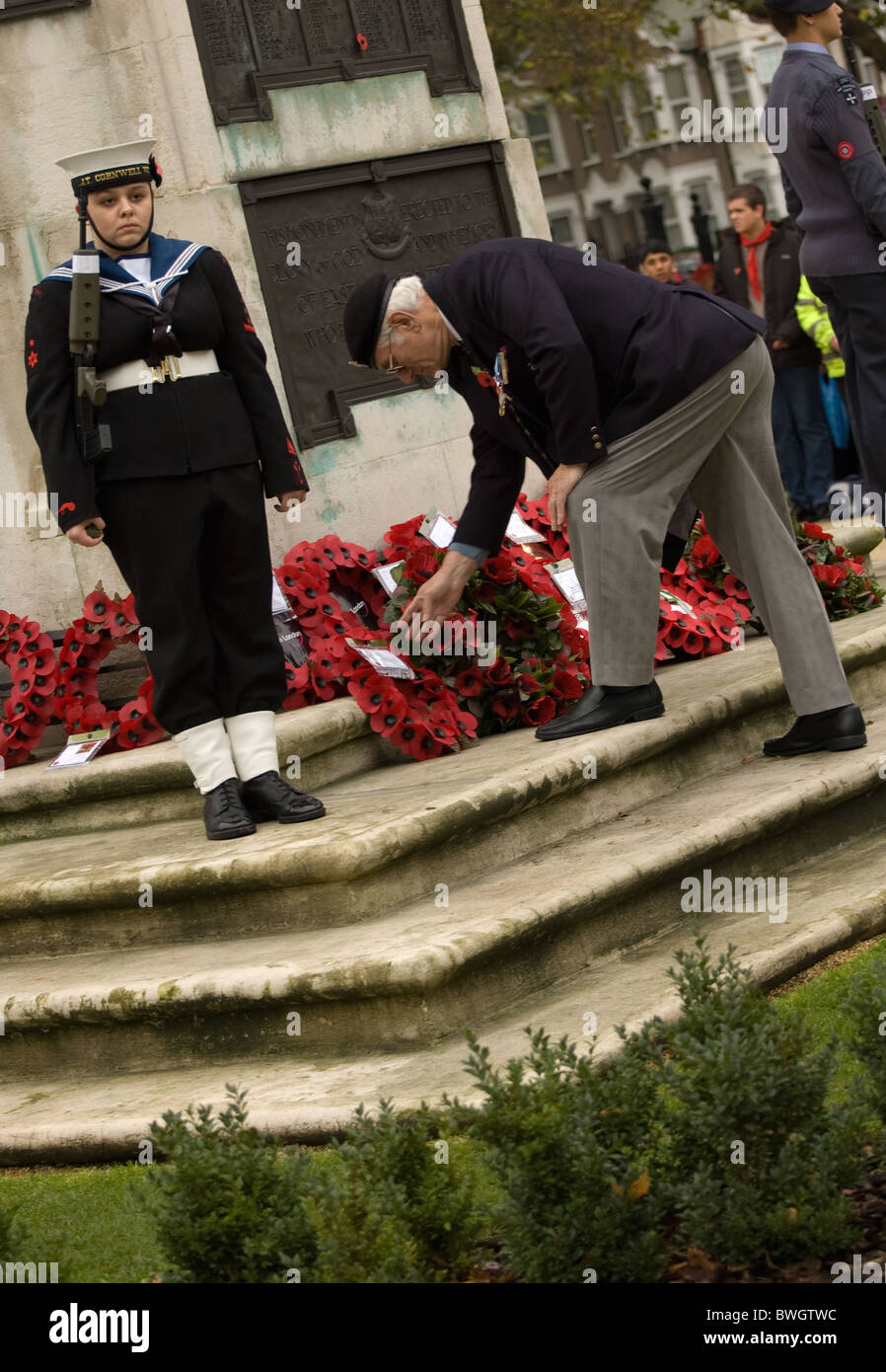 a member of the British legion lays a poppy wreath during remembrance ...
