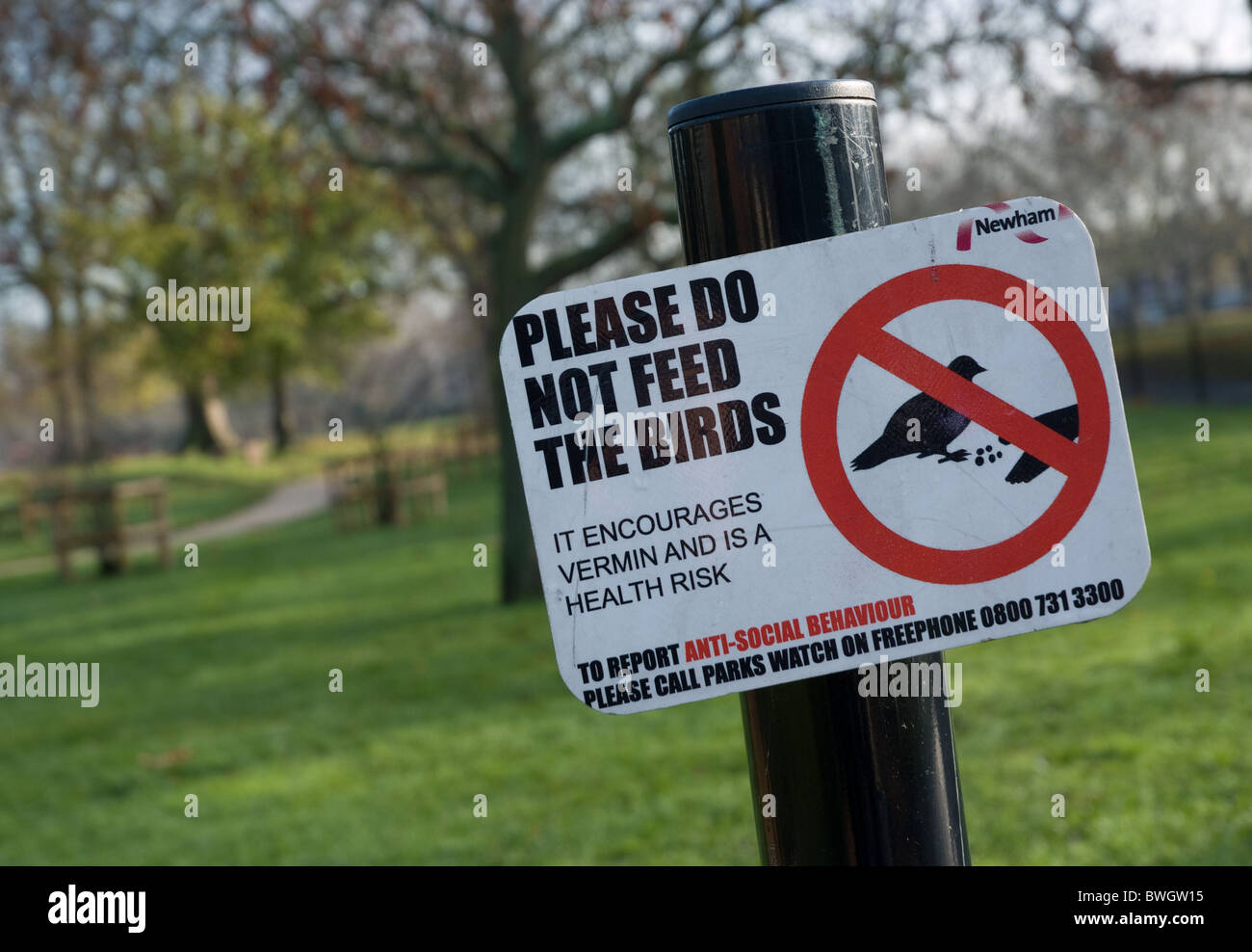 a please do not feed the birds sign, in central park , London borough ...