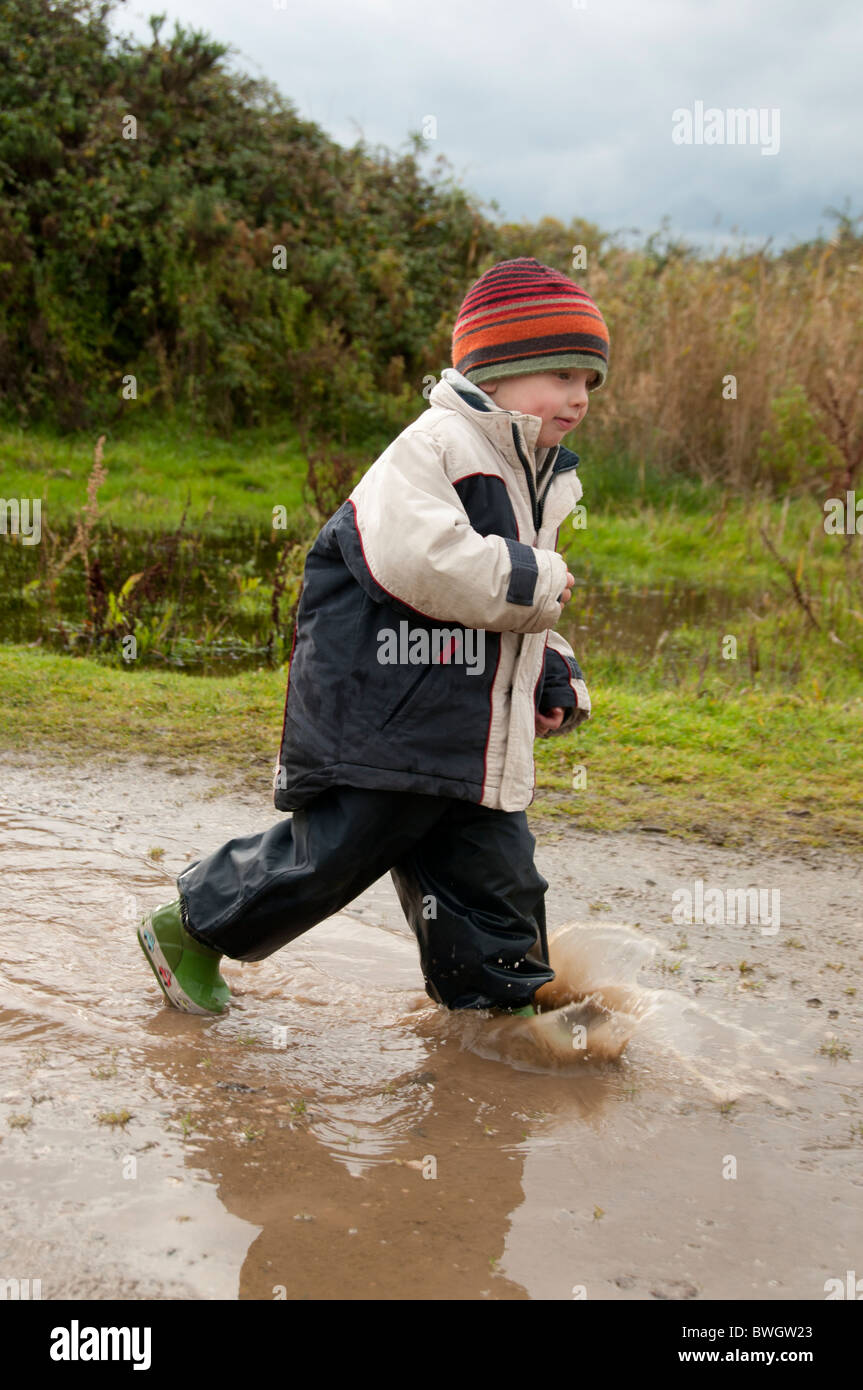 A Boy Playing In A Puddle High Resolution Stock Photography and Images ...