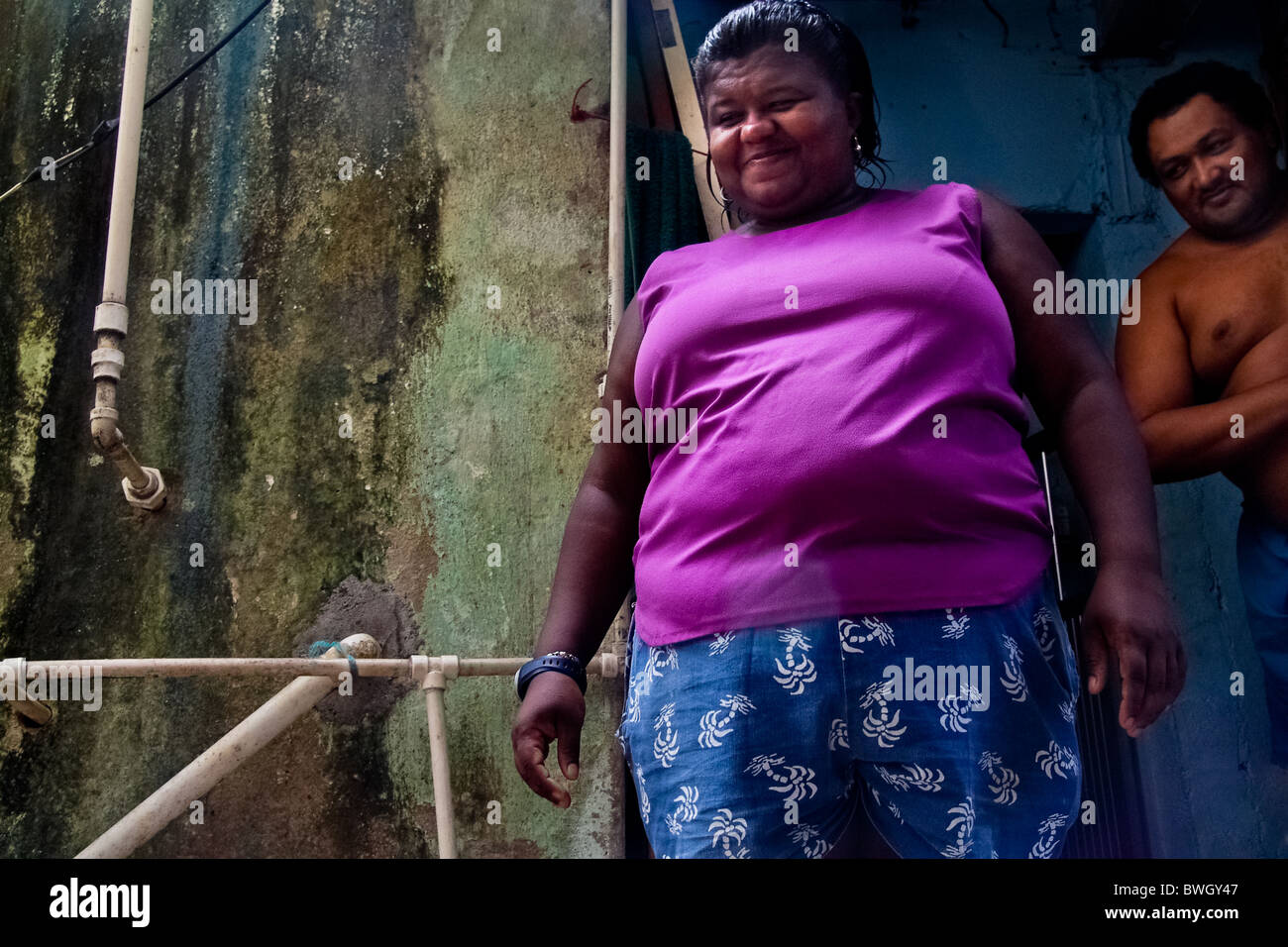 A Brazilian woman stands in the door of her humble house in Rocinha ...