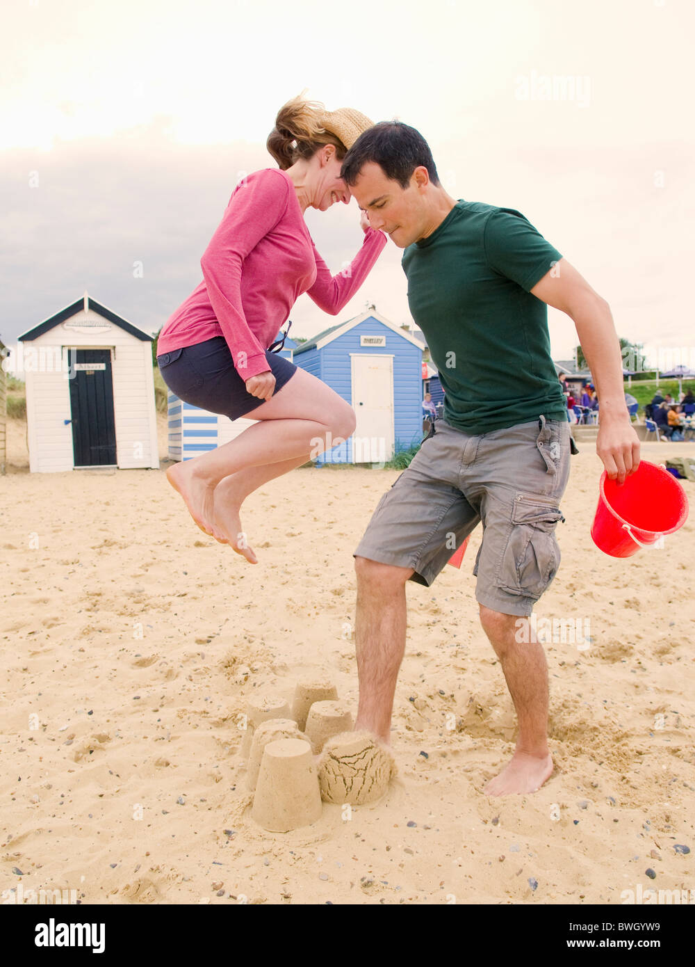Couple destroy sandcastles Stock Photo - Alamy