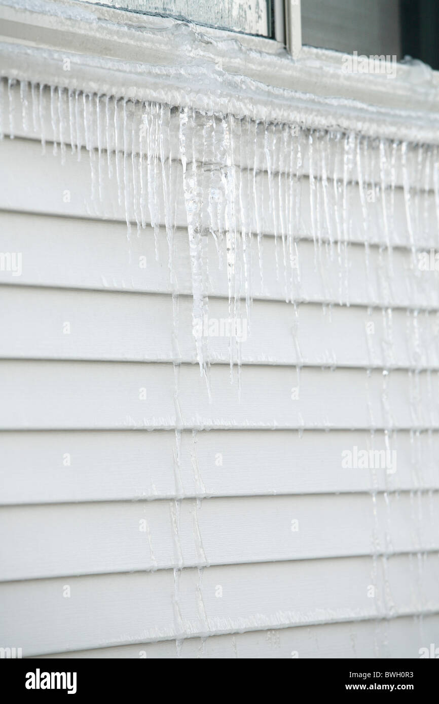 ice and icicles on the siding of a house Stock Photo - Alamy