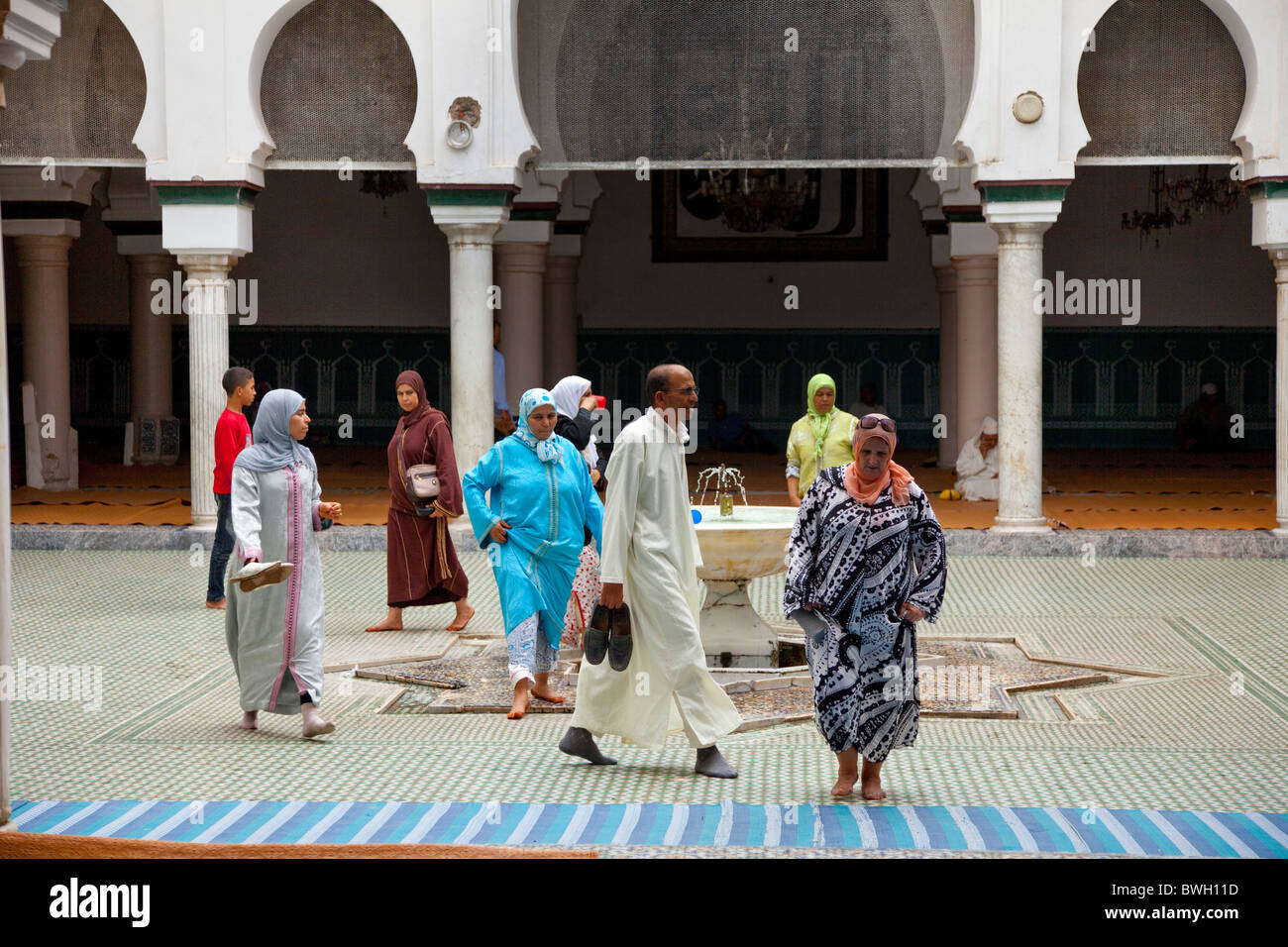 Islamic worshipers cleanse themselves at an ablution fountain at a ...
