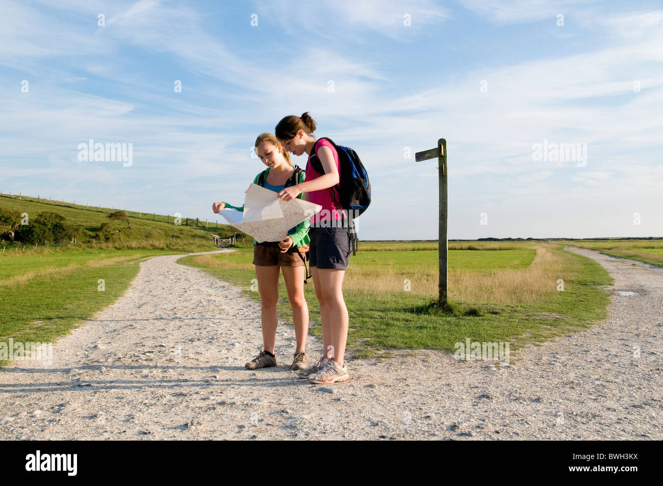 Female hikers check route on map Stock Photo - Alamy