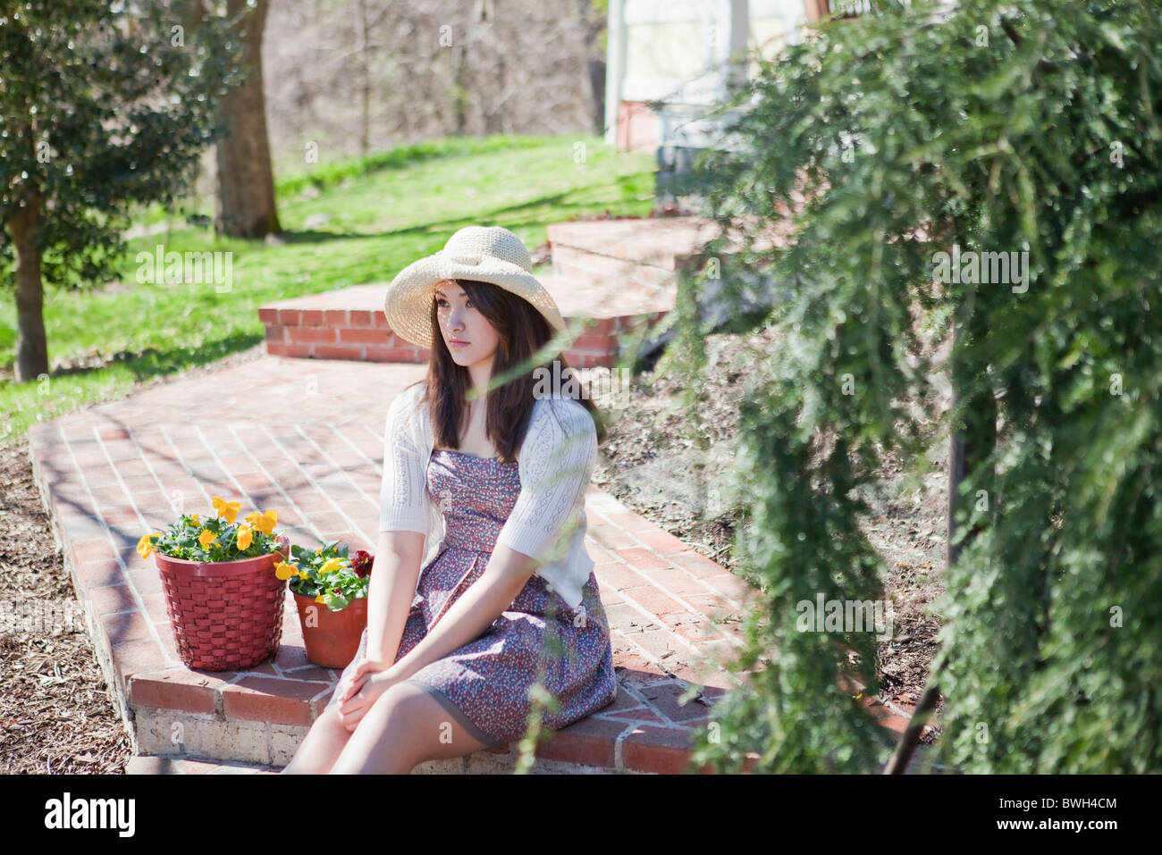 Girl sitting on steps Stock Photo - Alamy
