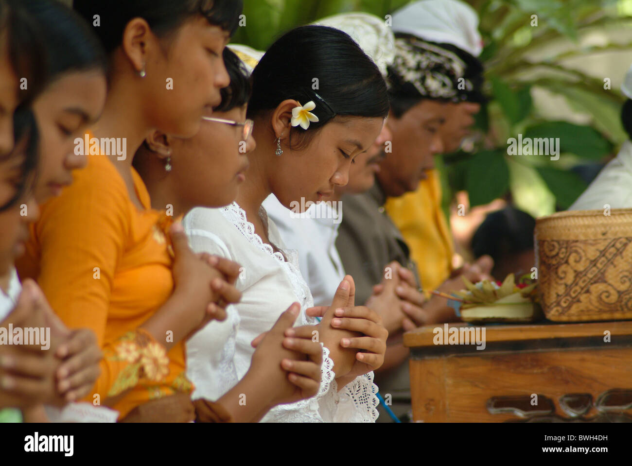 At a temple in Ubud, Bali, Hindu followers pray during a day called ...