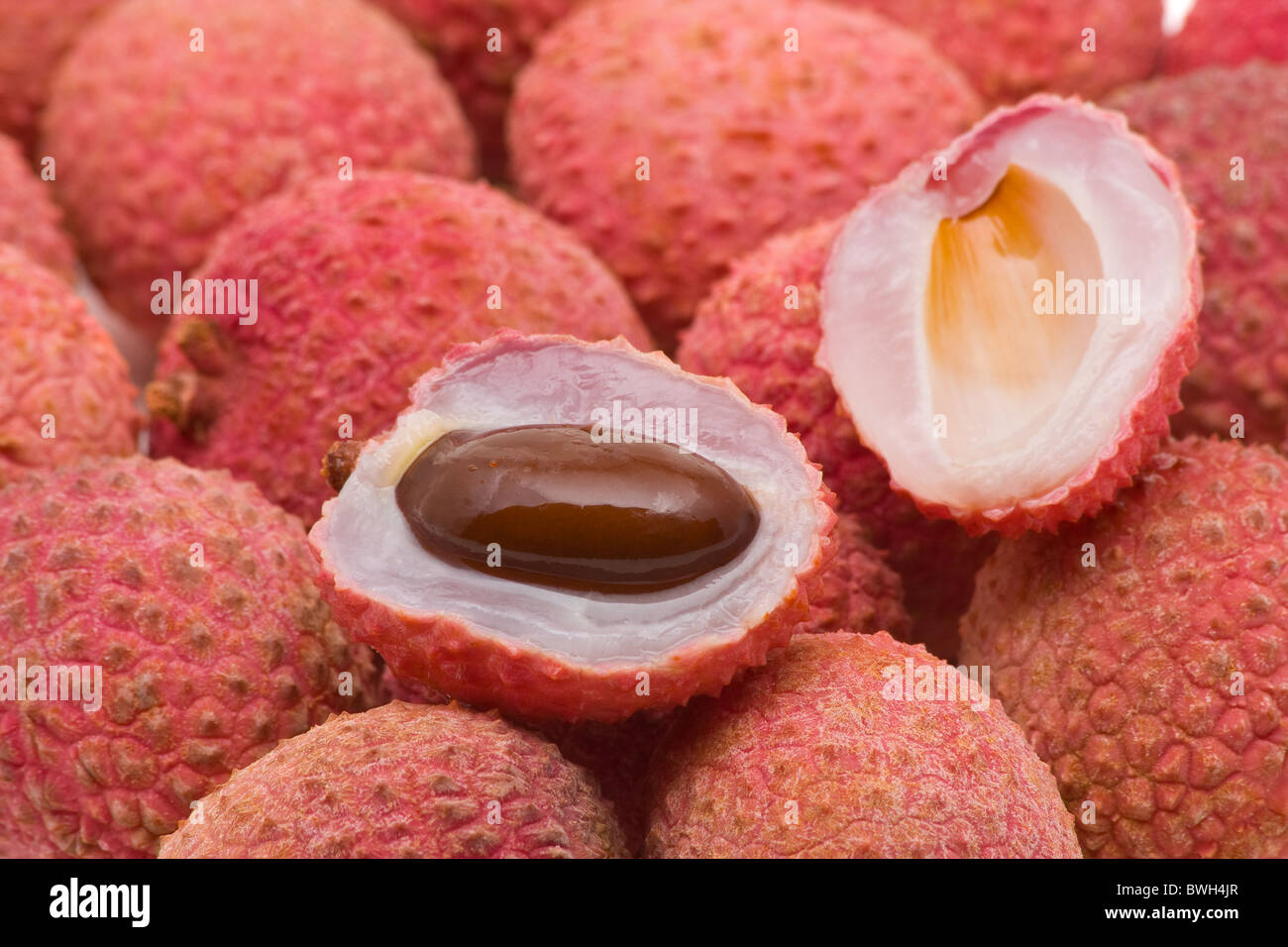 Open halfed lychee on lychee background Stock Photo - Alamy