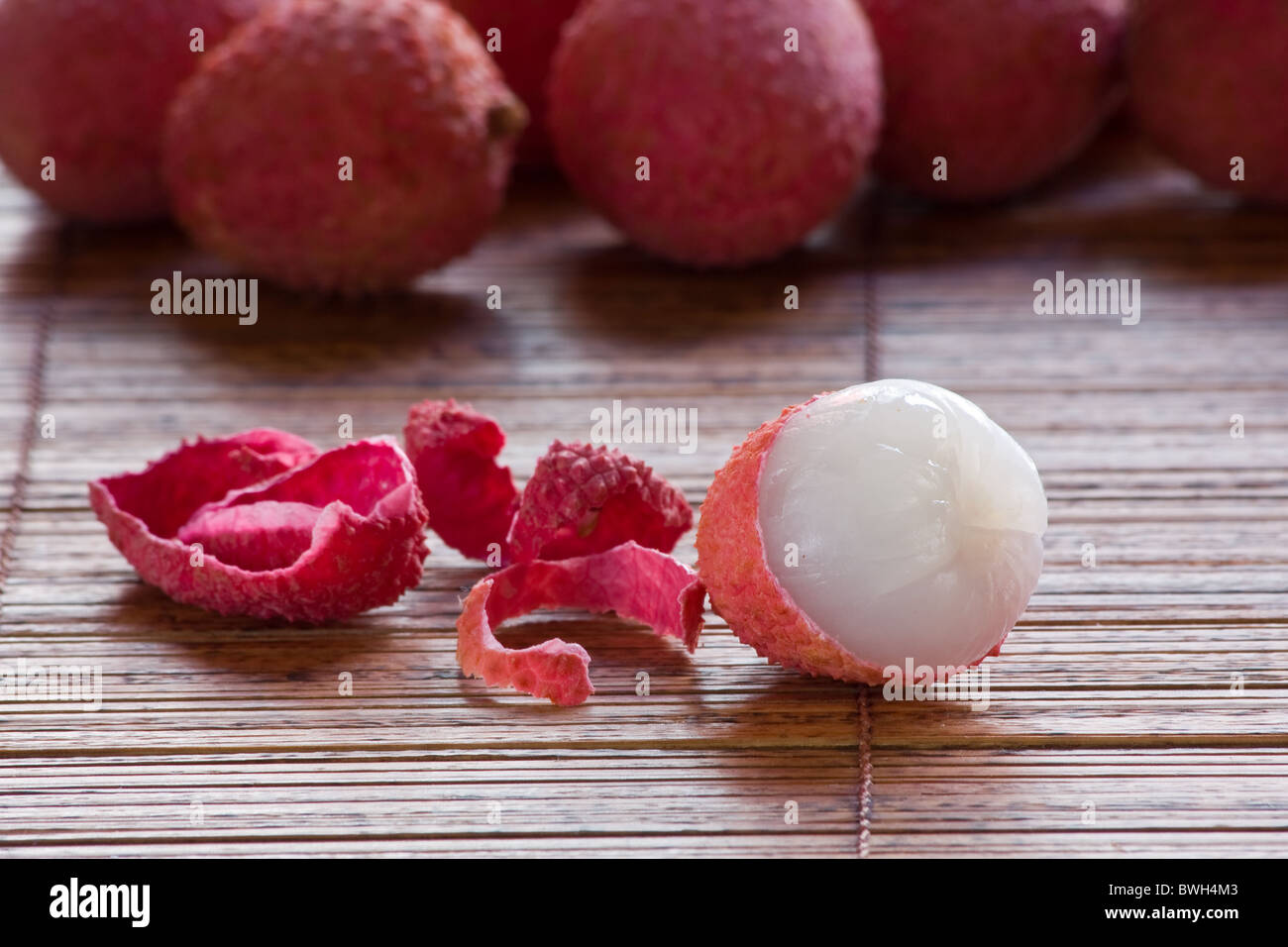 Whole and peeled lychee on bamboo mat Stock Photo - Alamy