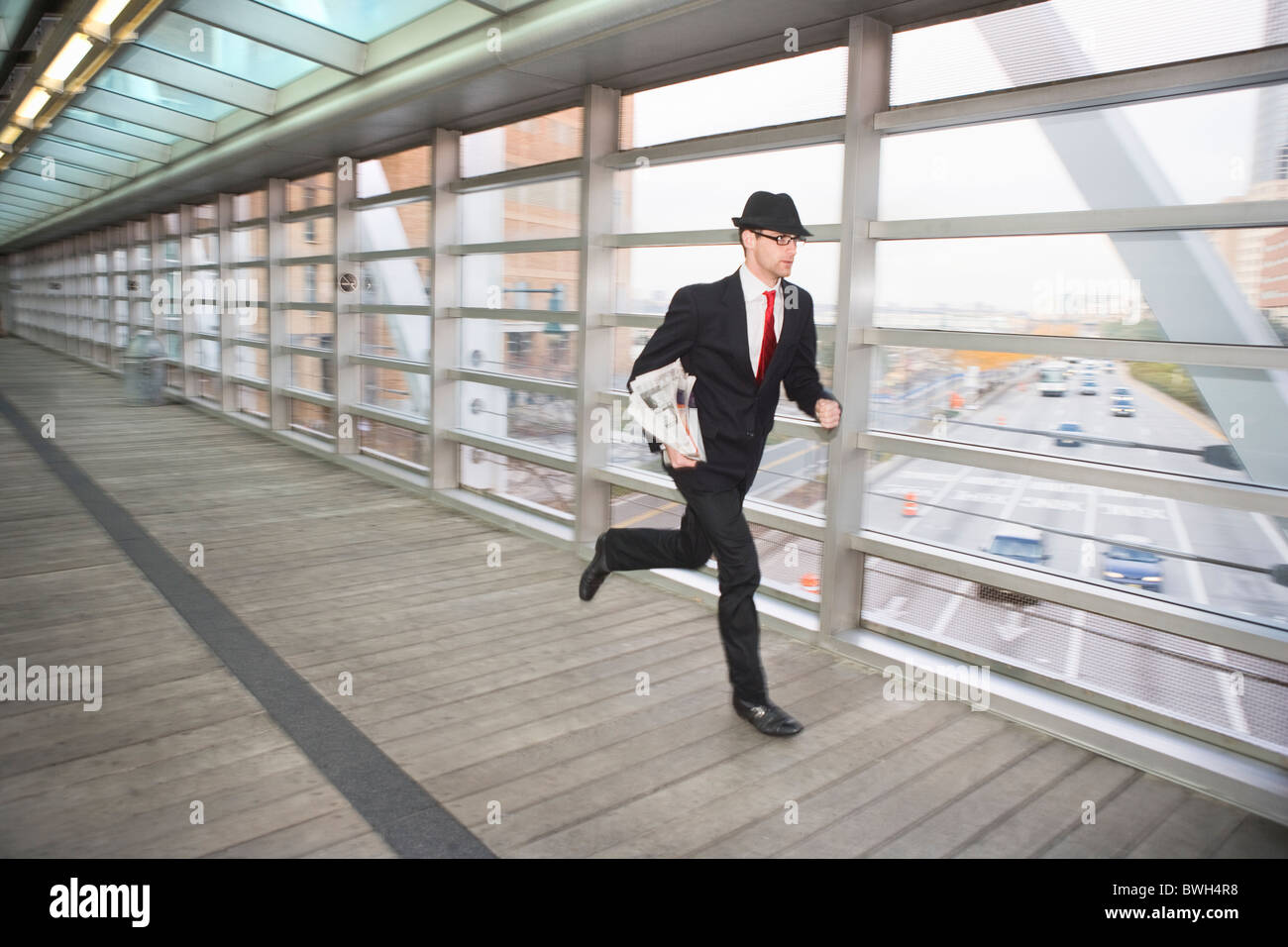 Man running over bridge Stock Photo - Alamy