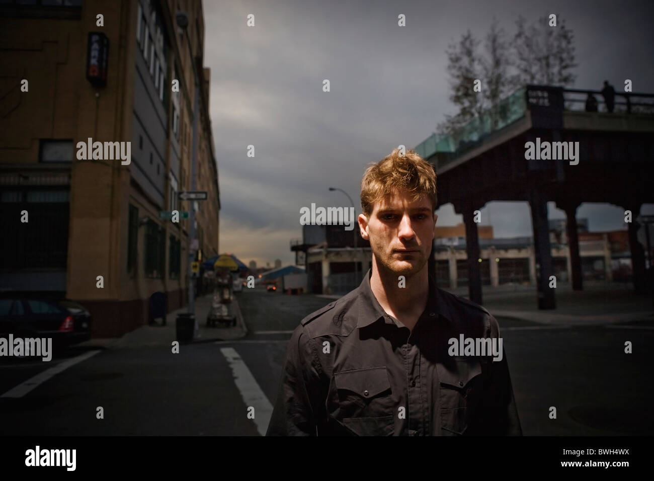 Man standing on city street Stock Photo - Alamy