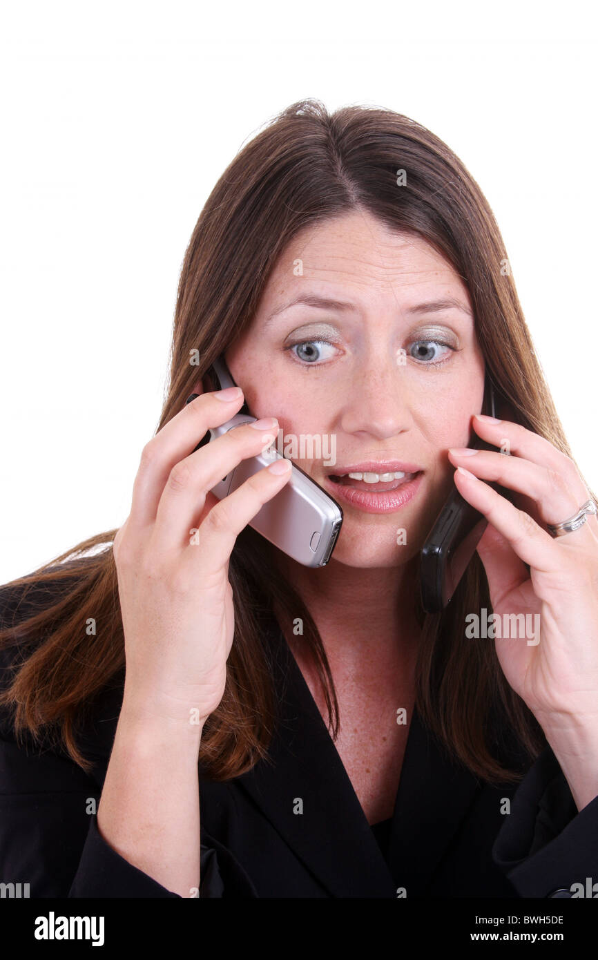 A young business woman on two cell phones Stock Photo - Alamy