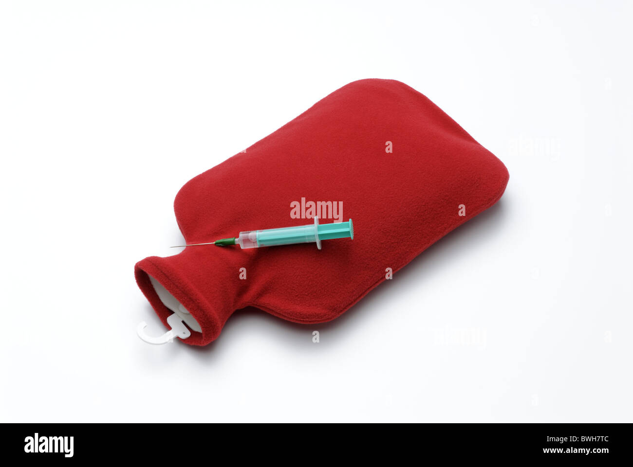 Hot water bottle with red cover and hypodermic syringe Stock Photo - Alamy