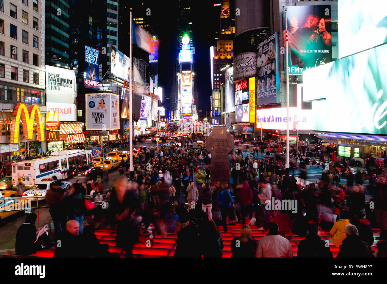 USA New York NYC Manhattan People sitting on lit red steps or walking ...