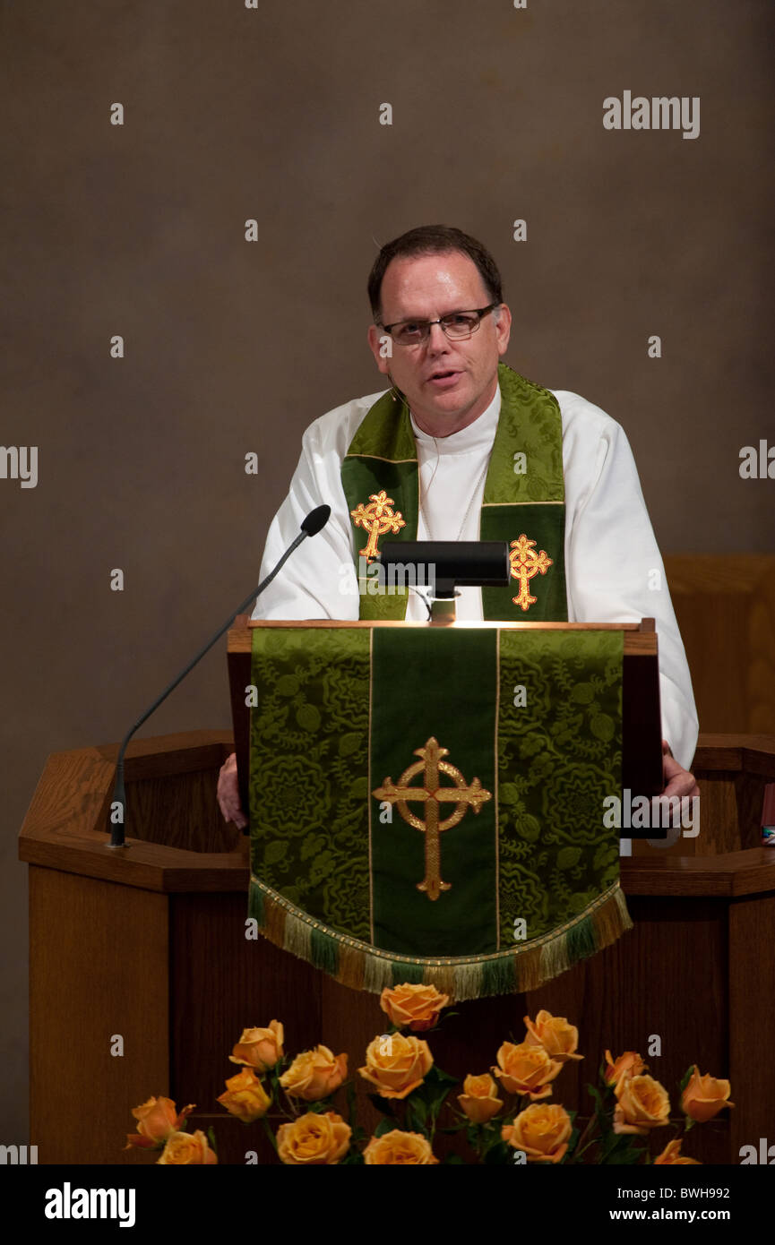Anglo male pastor delivers sermon from the pulpit during Sunday service ...
