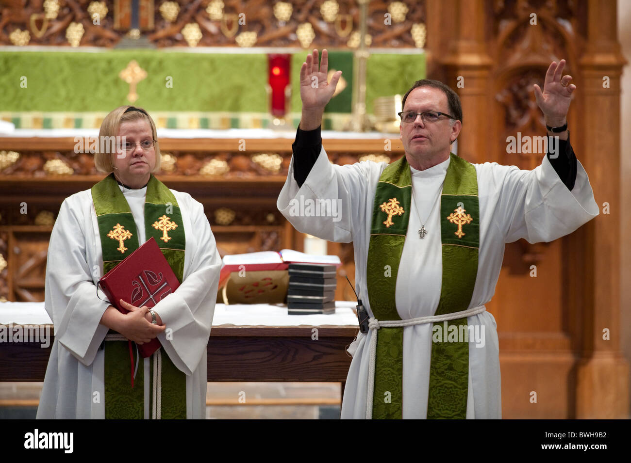 Anglo male minister and Anglo female assisting minister on pulpit ...