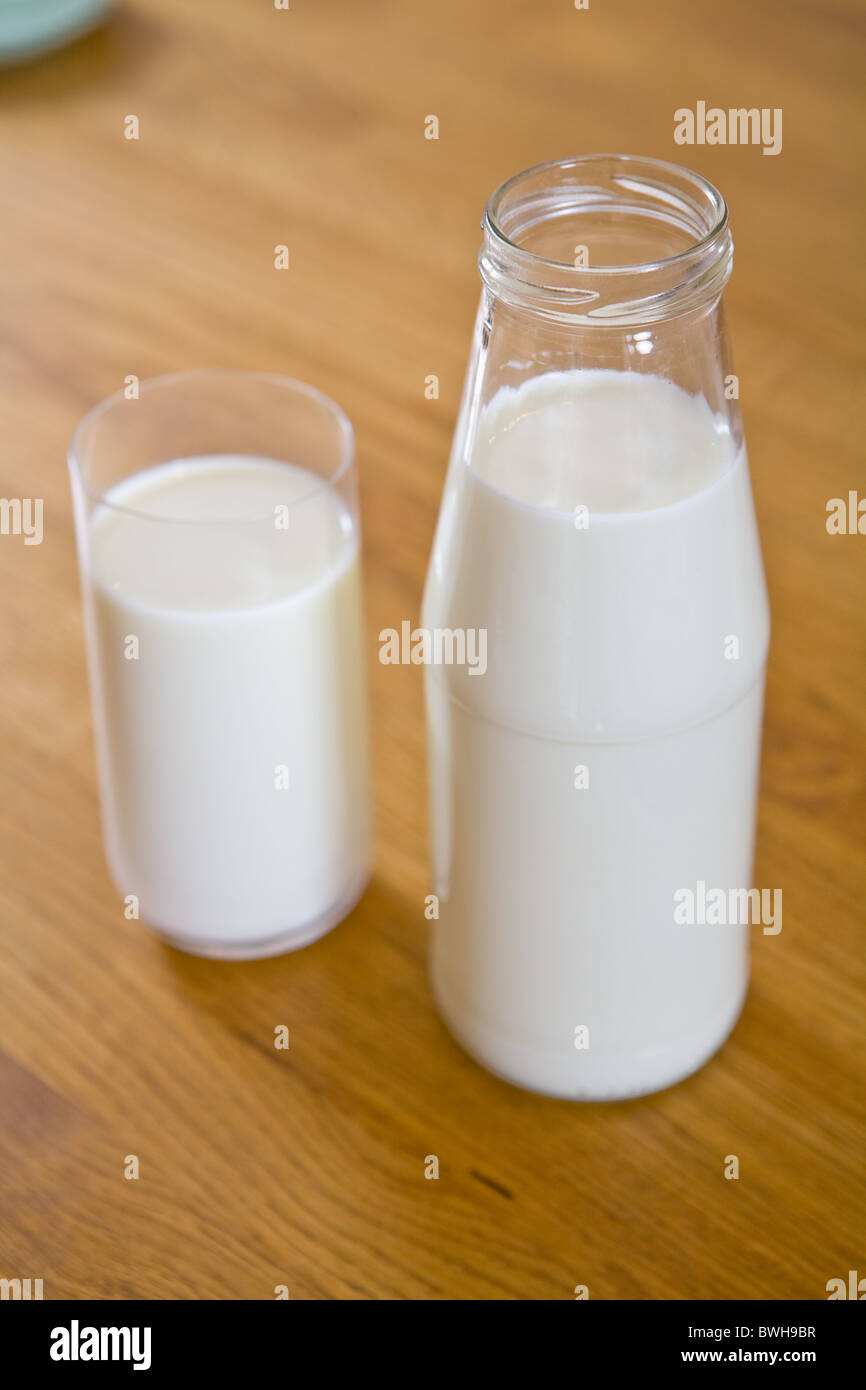 Traditional Bottle and Glass of Milk on Kitchen Table Stock Photo - Alamy