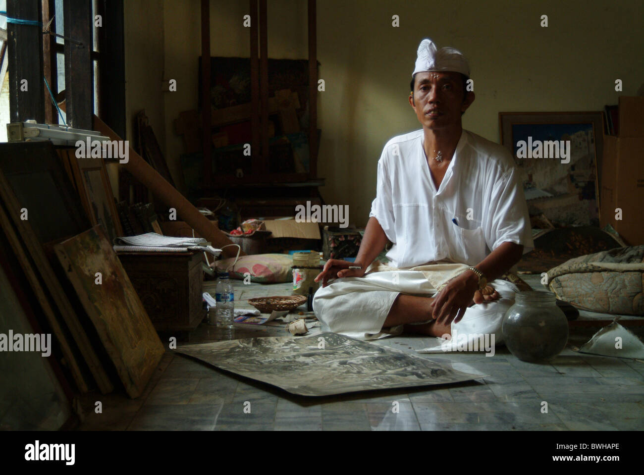 An artist paints in his studio in the village of Ubud, Bali, Indonesia ...