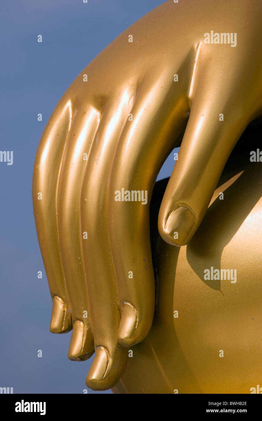The gold hand of a large Buddhist statue is on display at a temple in ...