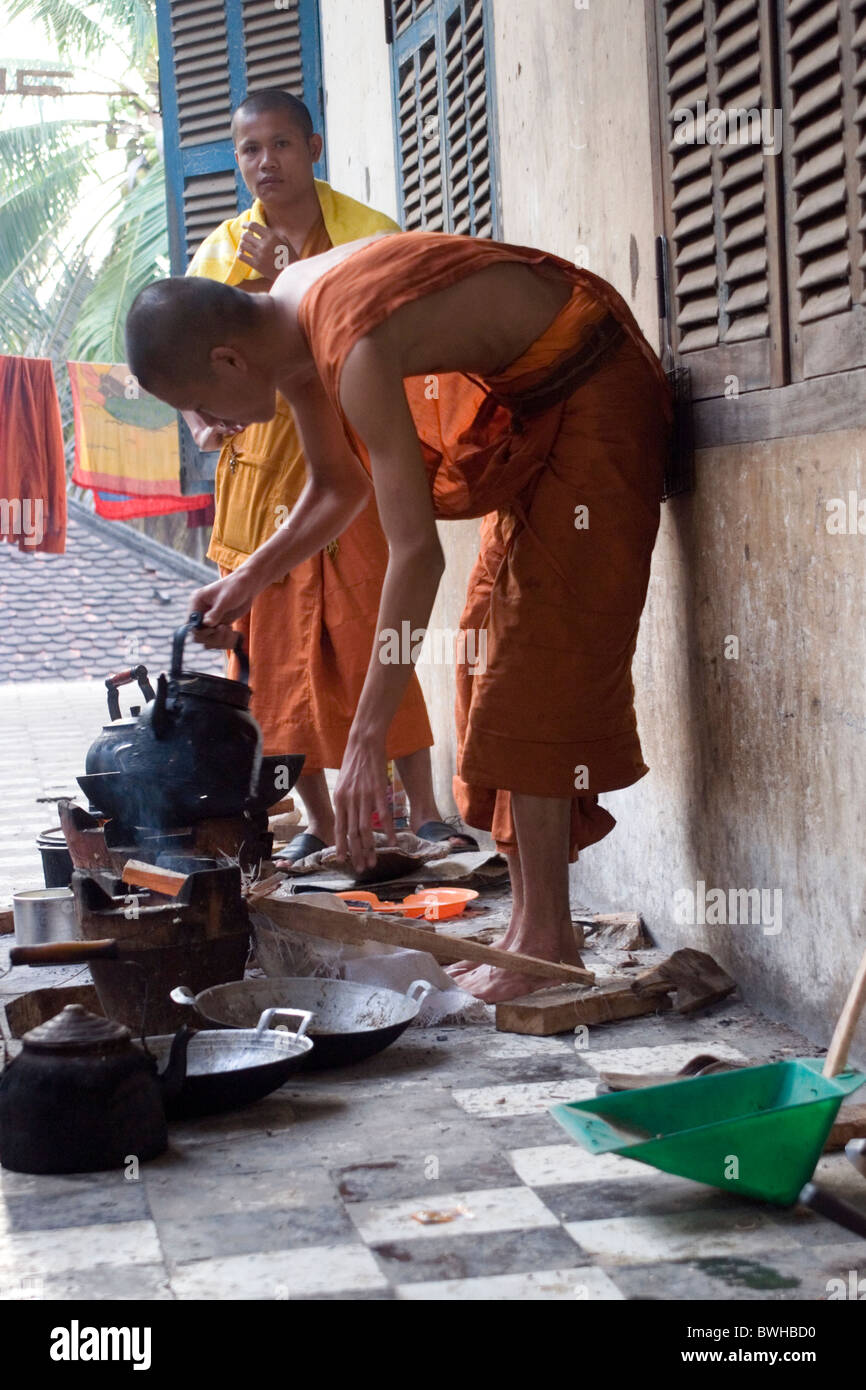 Buddhist monks are cooking dinner with a wood burning stove at Wat ...