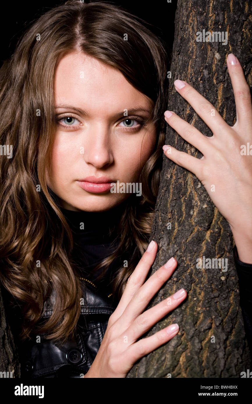 Photo Of Young Beautiful Girl Embracing Tree Trunk And Looking At