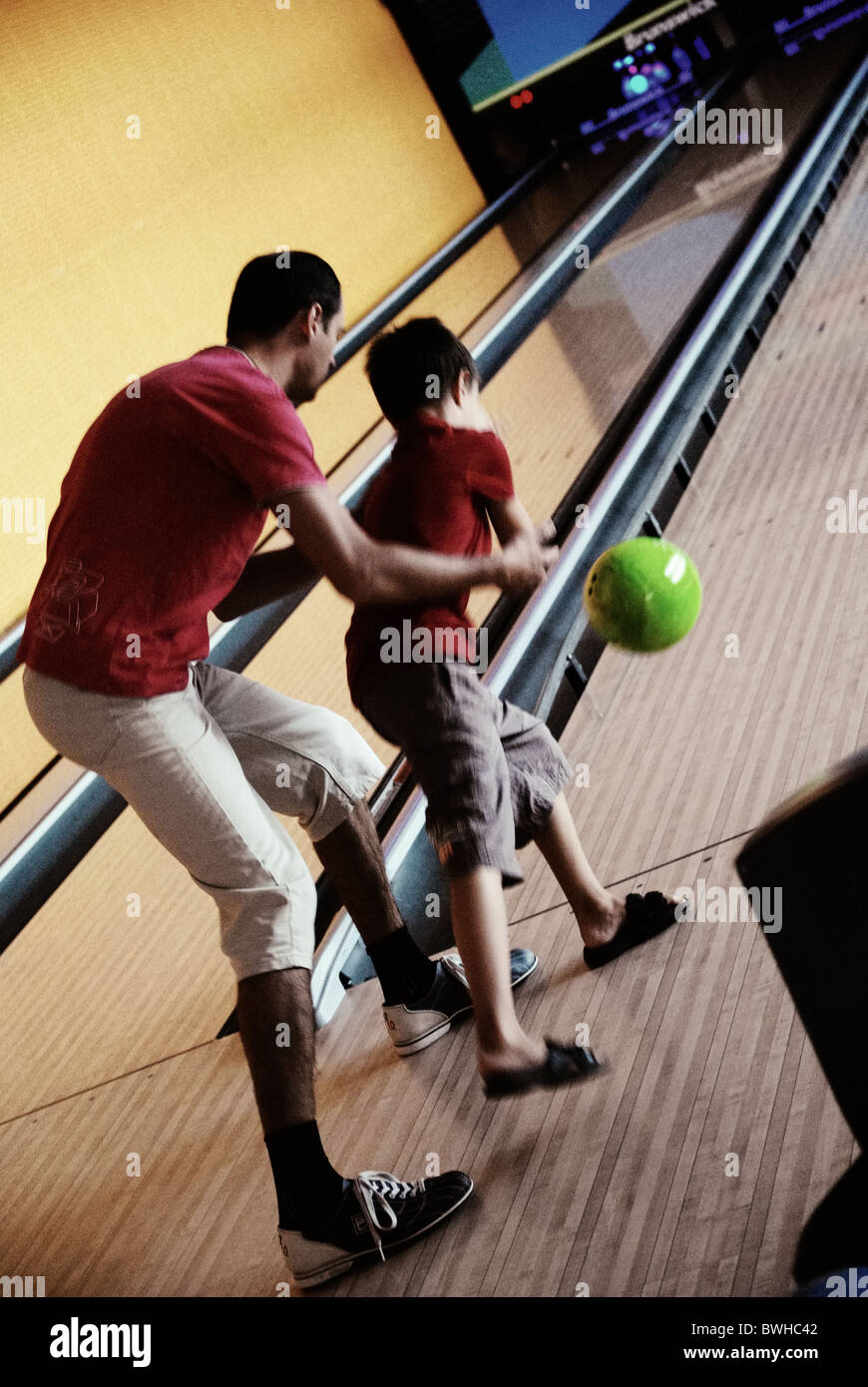 Father and son in a bowling alley Stock Photo - Alamy