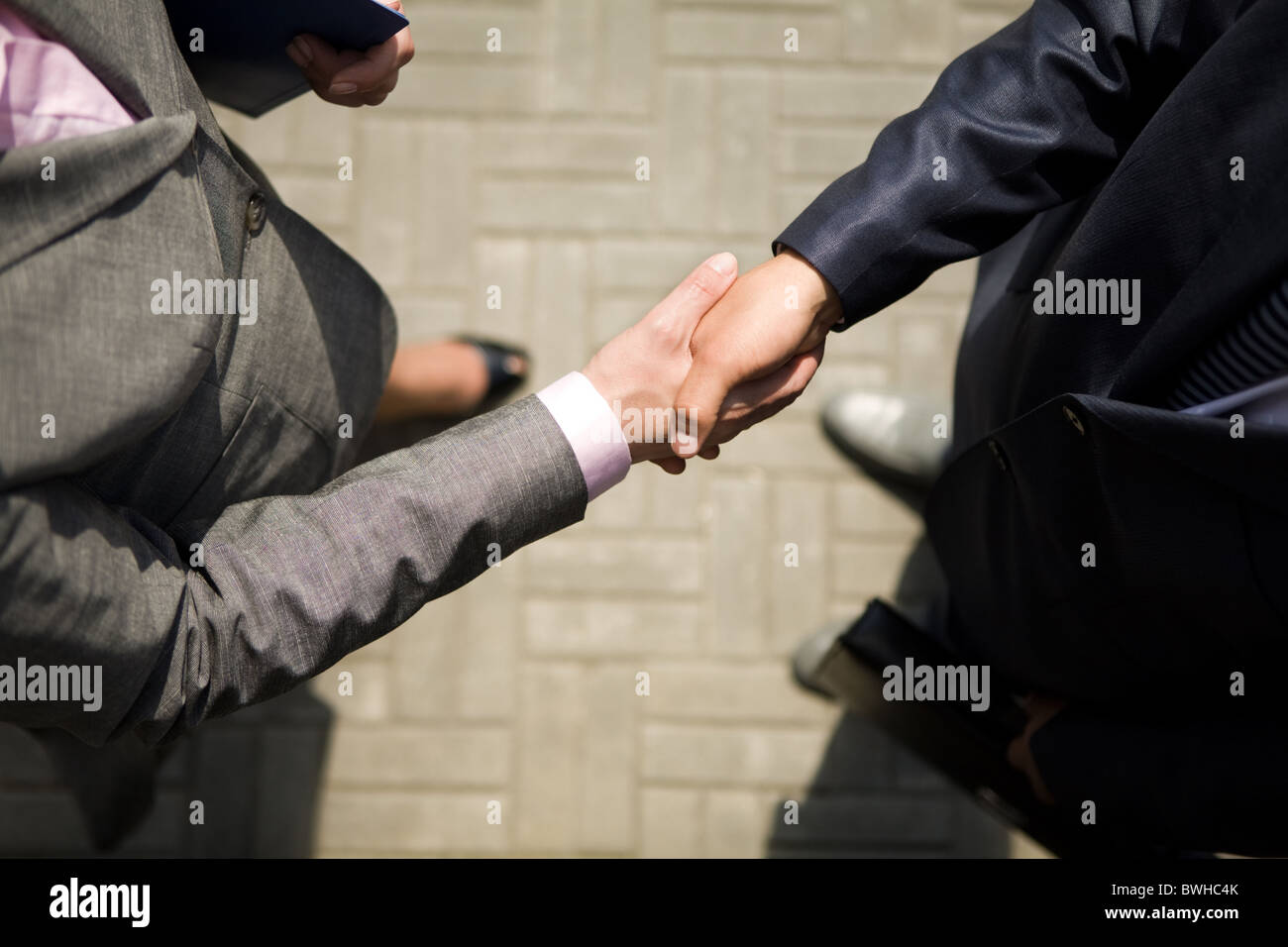 Above view of successful business partners handshaking after striking ...