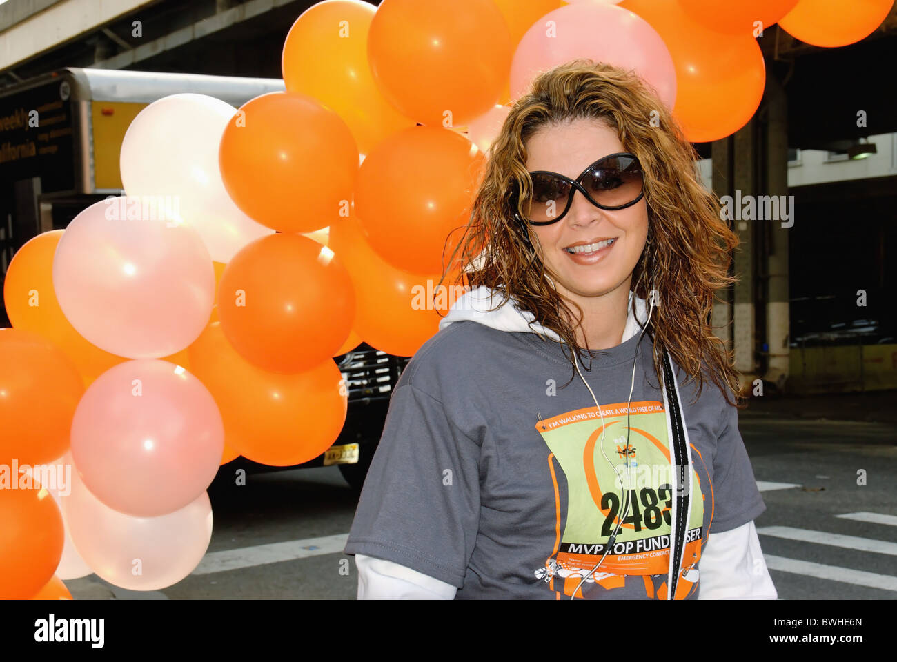 Volunteer in NYC Walk MS charity event, young woman by balloons ...