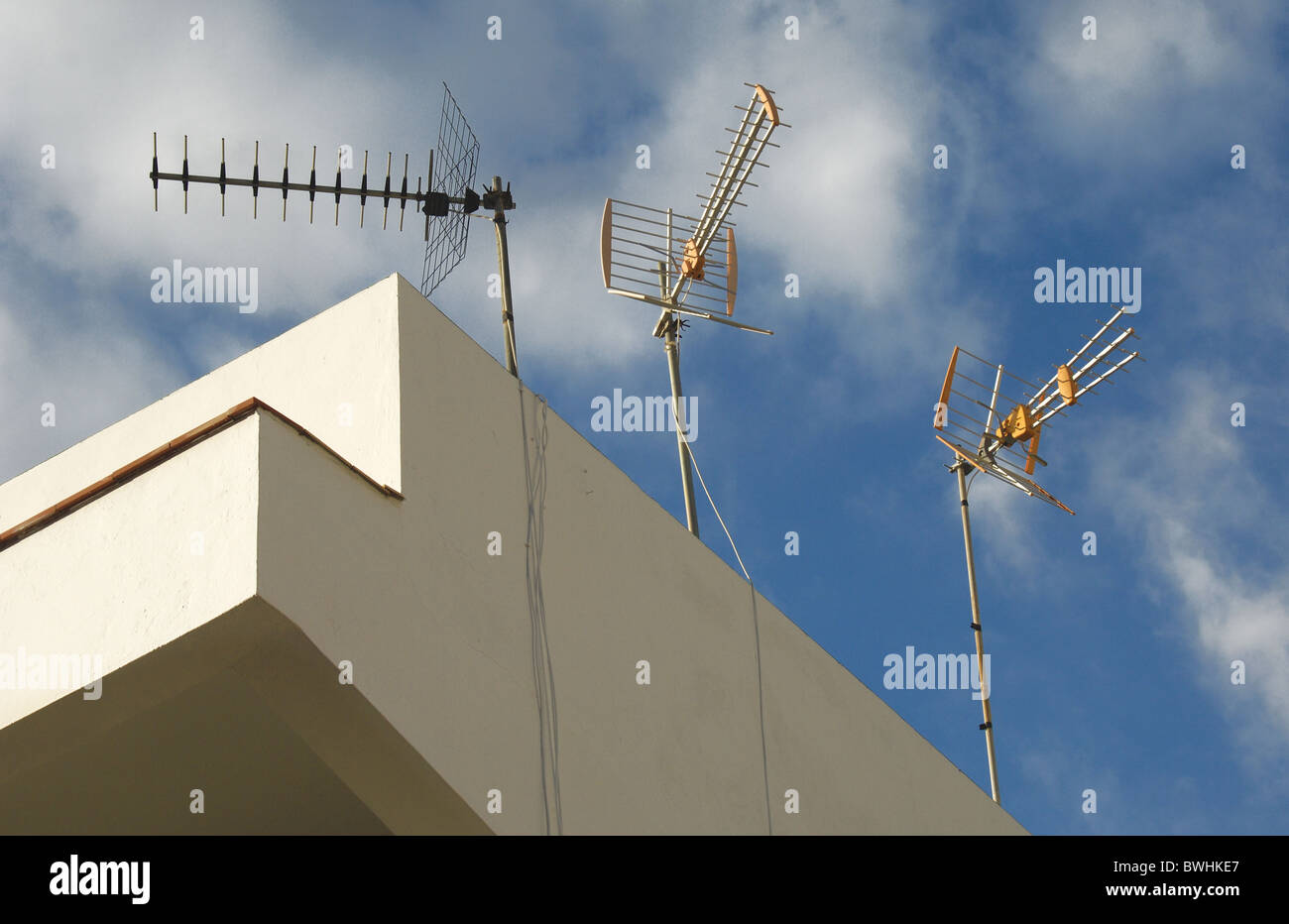 Three antennas on a rooftop Stock Photo - Alamy